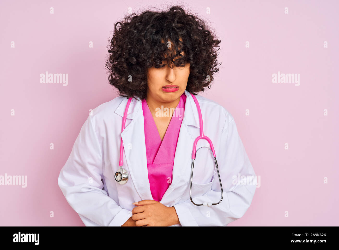 Young arab doctor woman with curly hair wearing stethoscope over ...