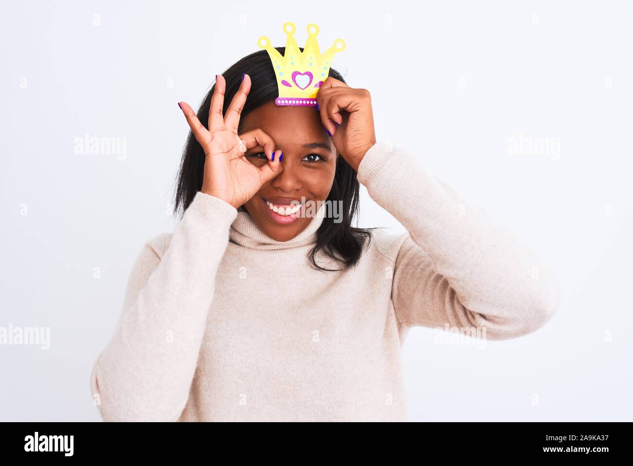 Young african american woman wearing pretend queen crown over isolated ...