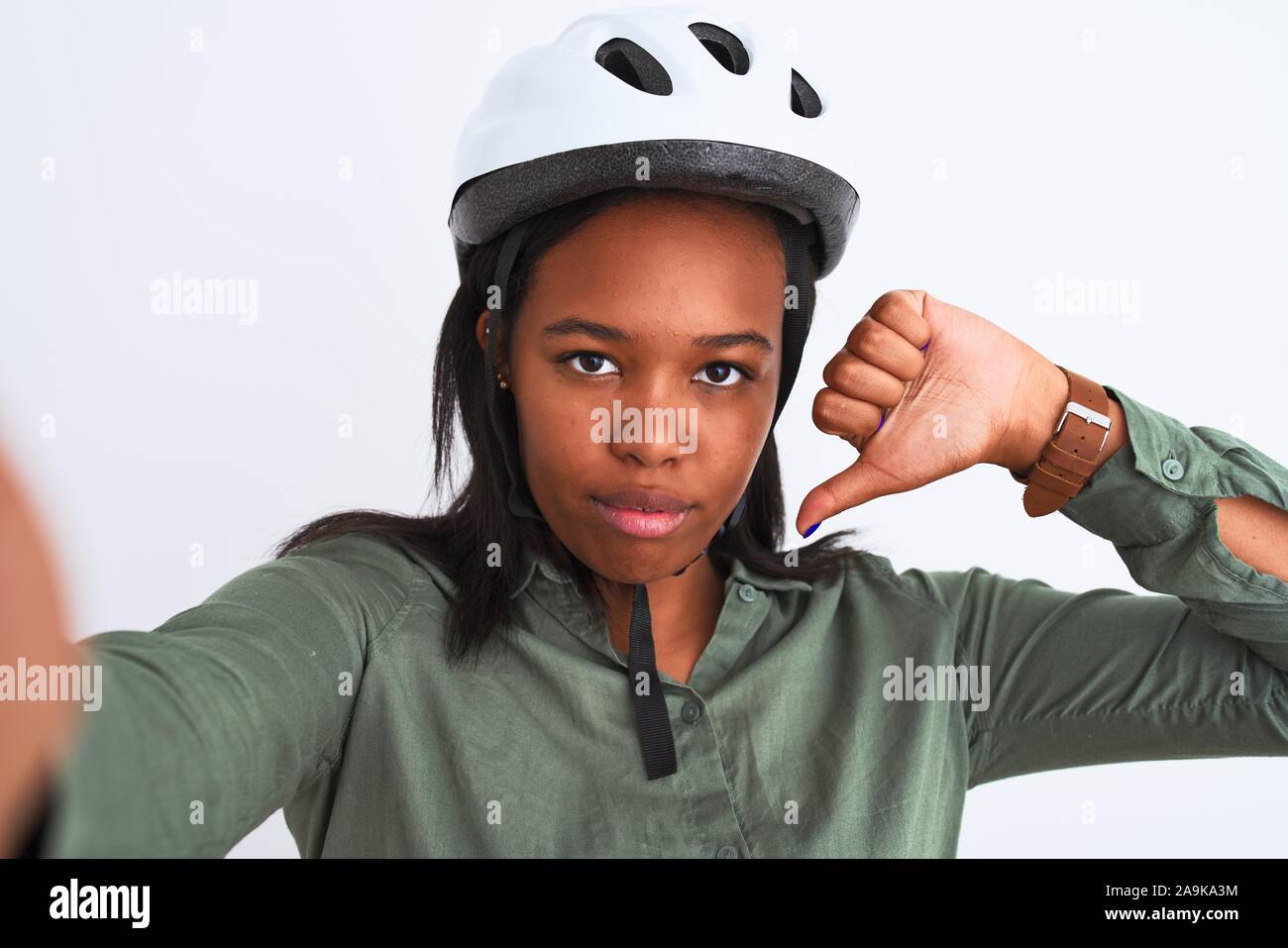 Young african american woman wearing bike helmet taking a selfie over ...