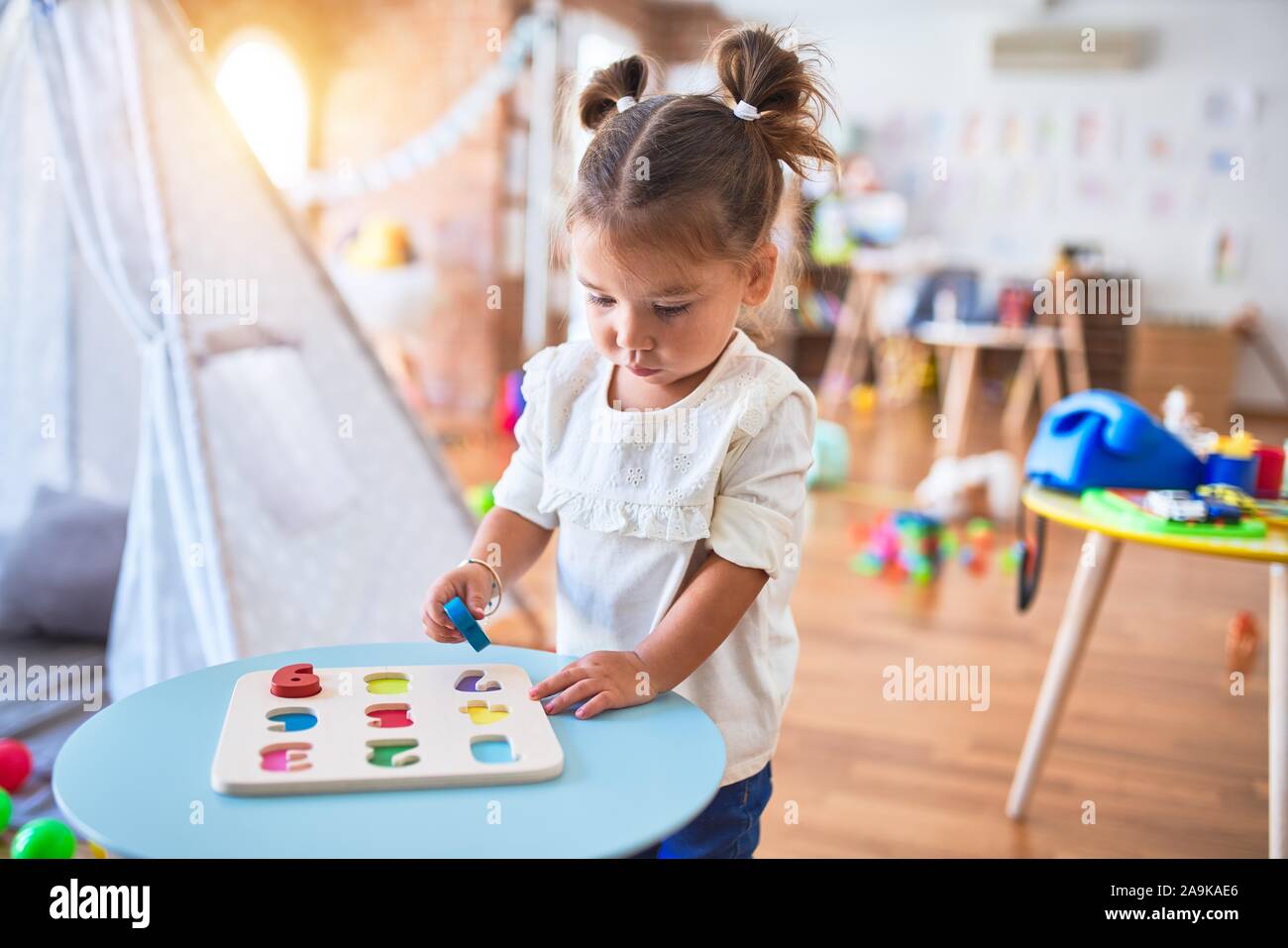 Young beautiful toddler learning mathematics playing with maths game at ...