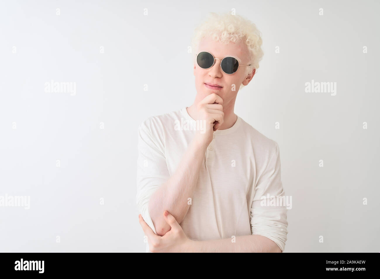 Young albino blond man wearing t-shirt and sunglasses over isolated ...