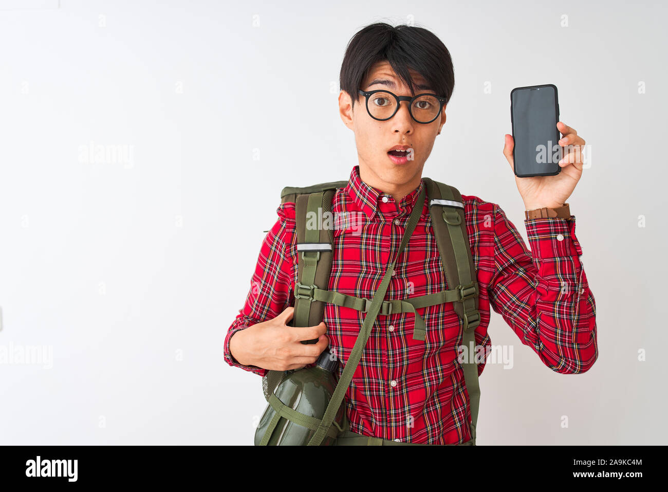 Chinese hiker man wearing canteen holding smartphone over isolated ...