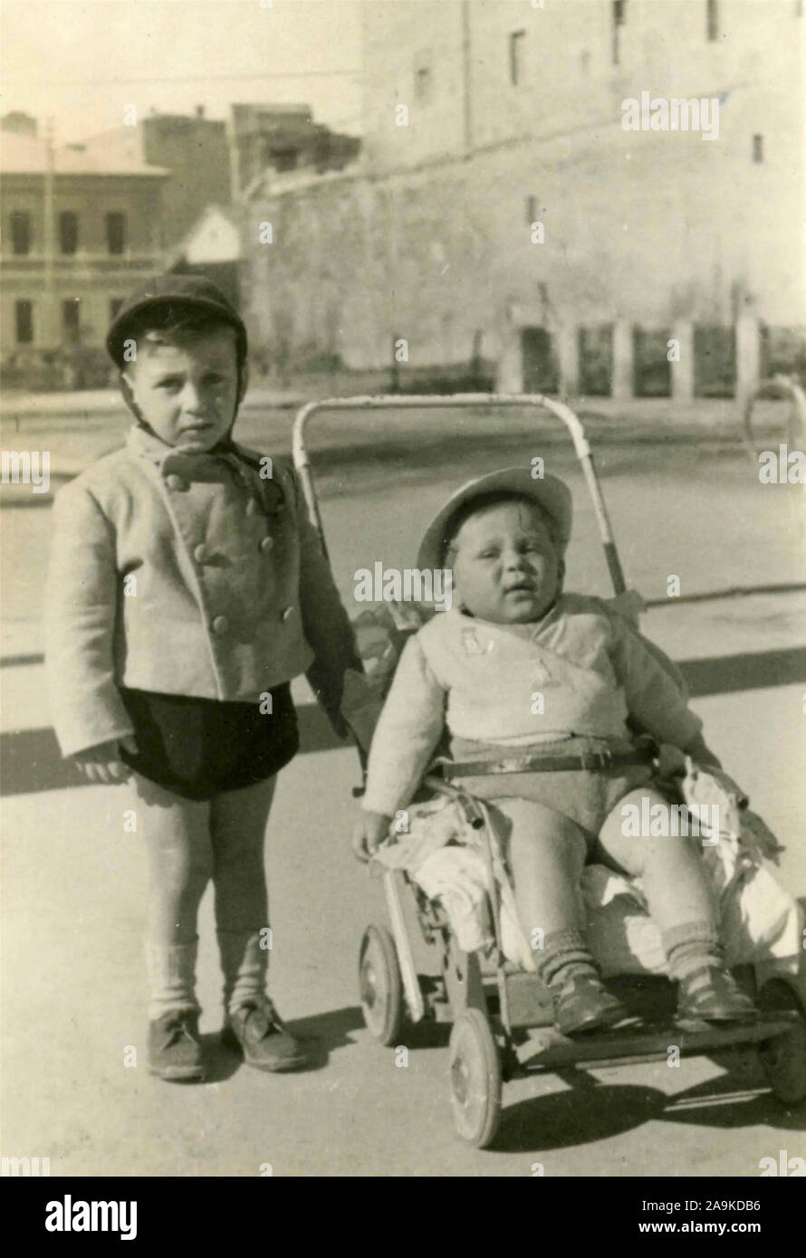 Two children, one on the stroller, Italy Stock Photo - Alamy