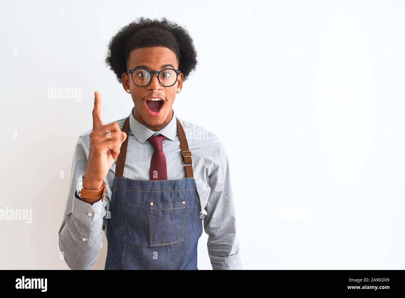 Young african american shopkeeper man wearing apron glasses over ...
