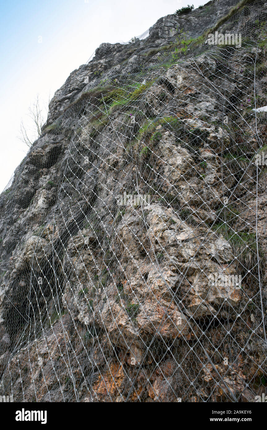 rockfall protection nets, installed to protect an rock wall Stock Photo ...