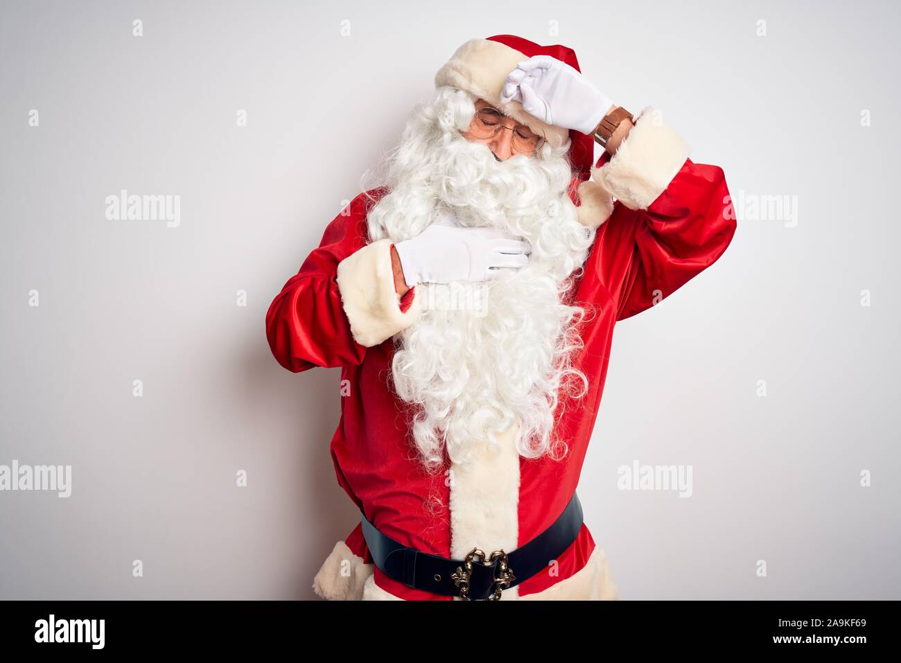 Middle age handsome man wearing Santa costume standing over isolated ...