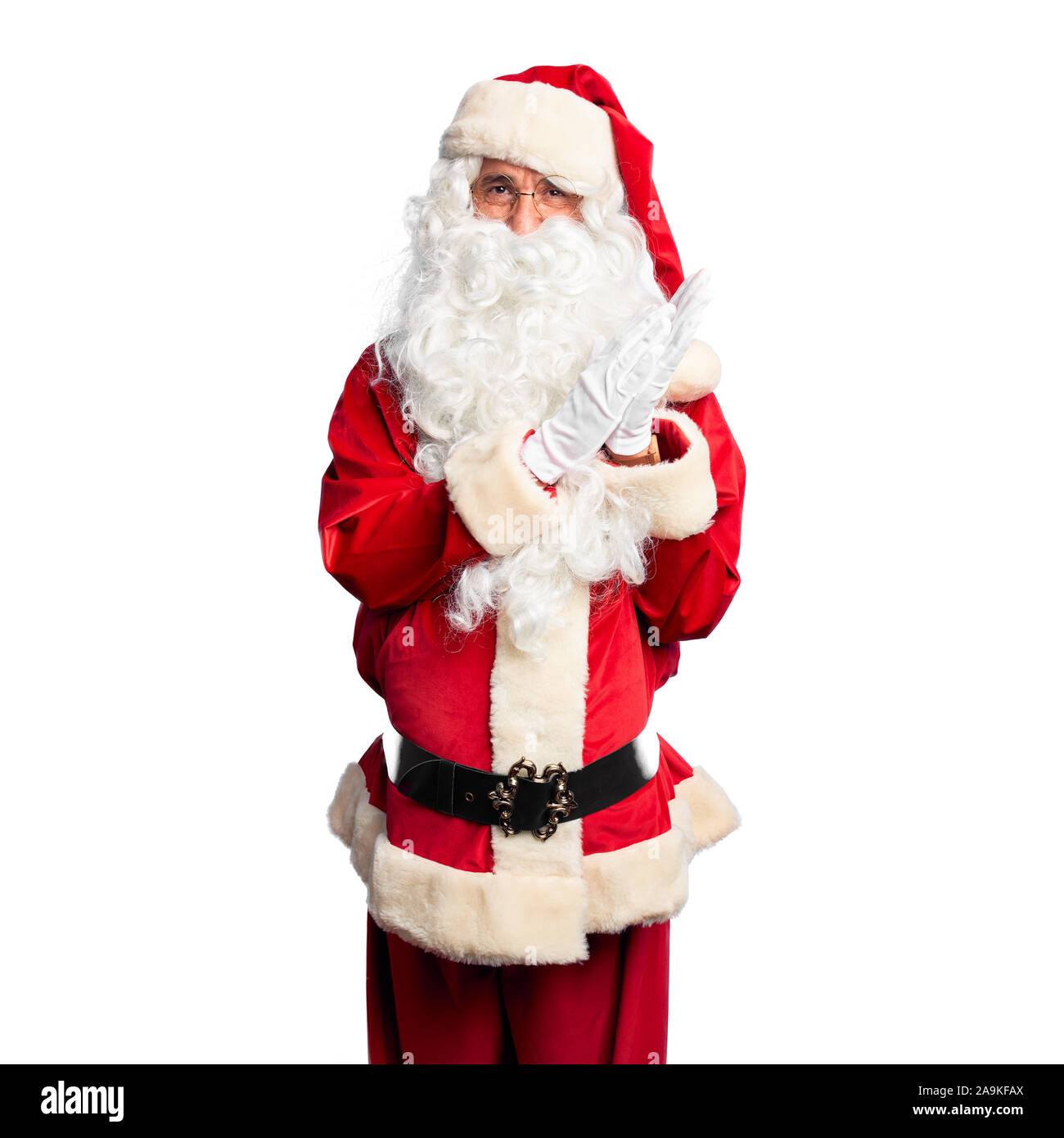 Middle age handsome man wearing Santa Claus costume and beard standing ...