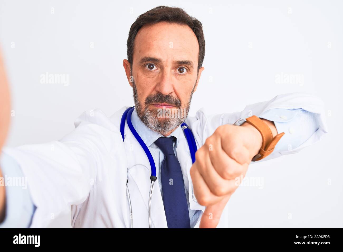 Middle age doctor man wearing stethoscope make selfie over isolated ...