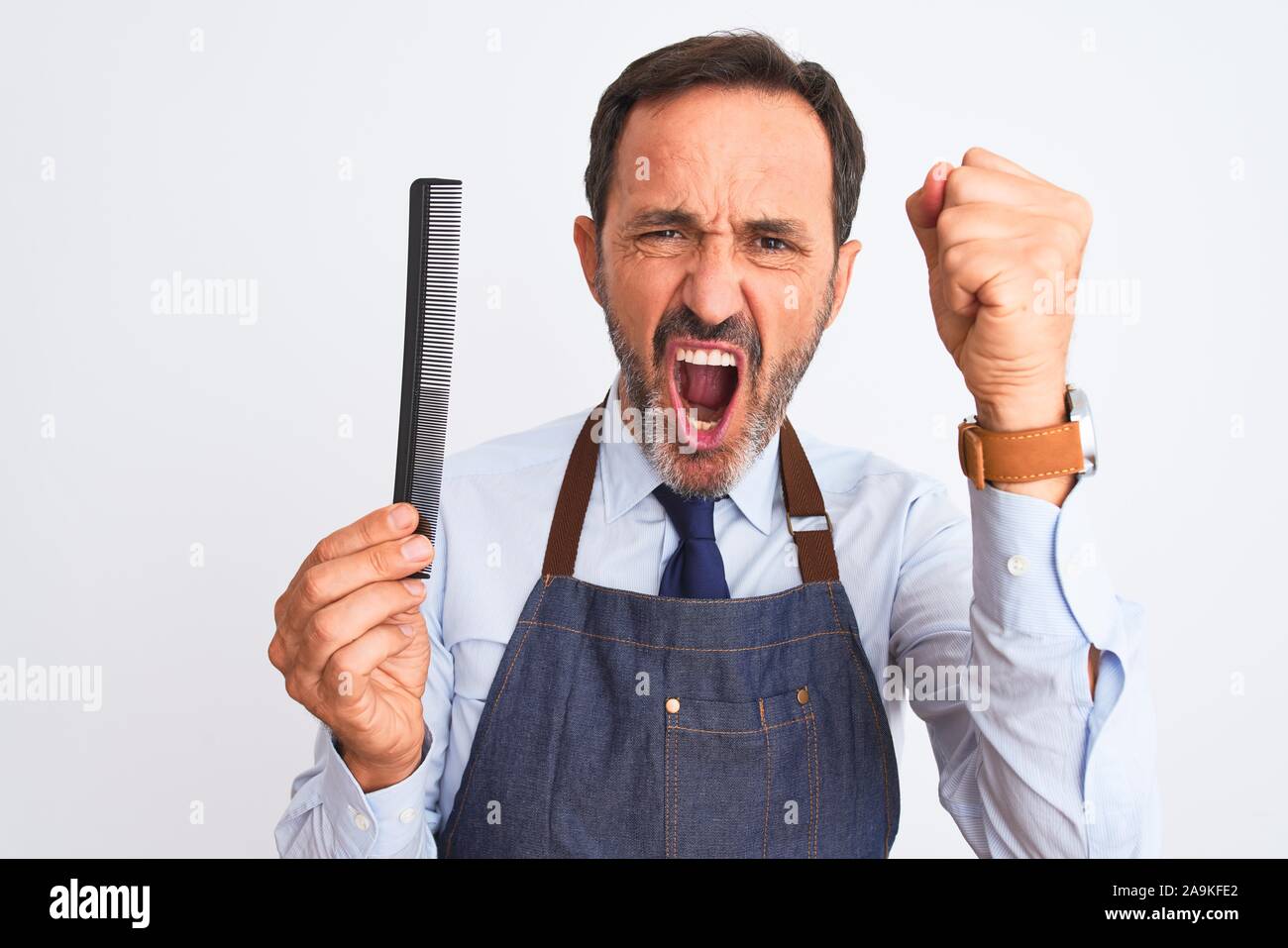 Middle age barber man wearing apron holding hair comb over isolated ...