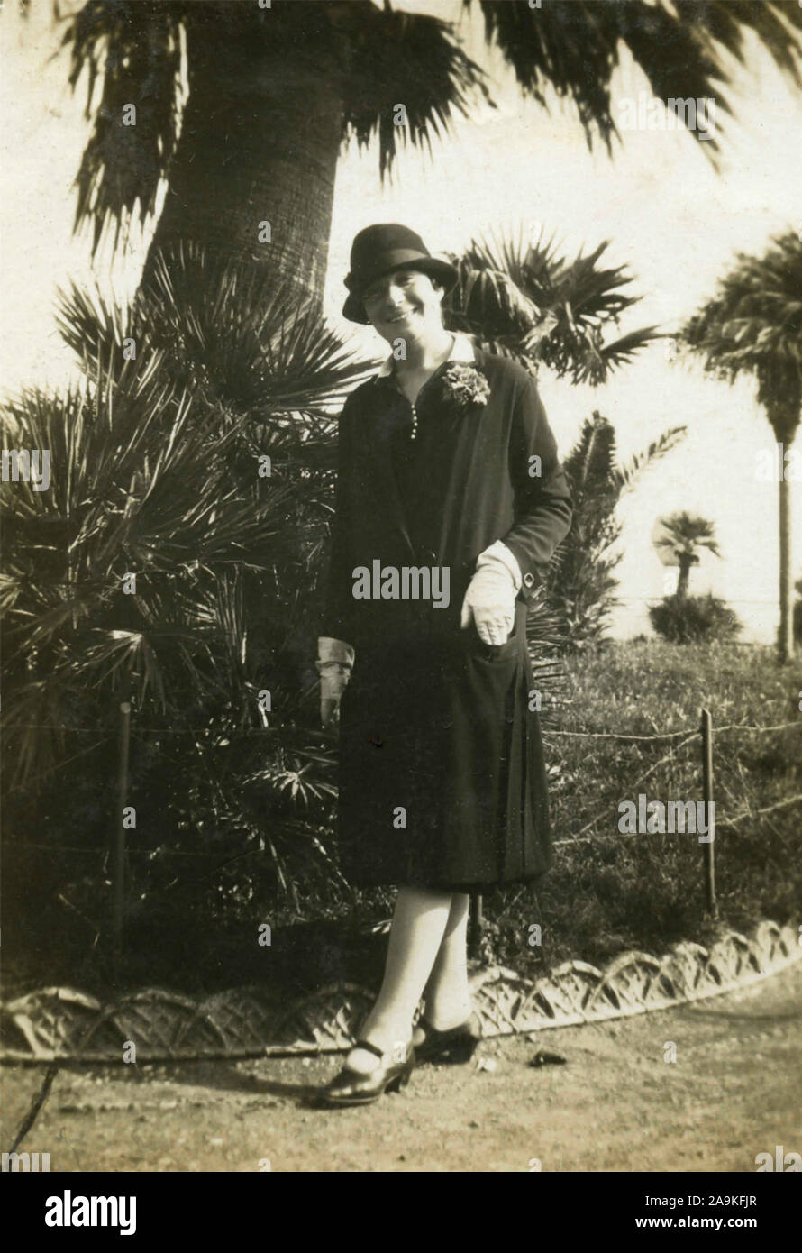 An elegant woman with the hat to the gardens of Genoa, Italy Stock ...