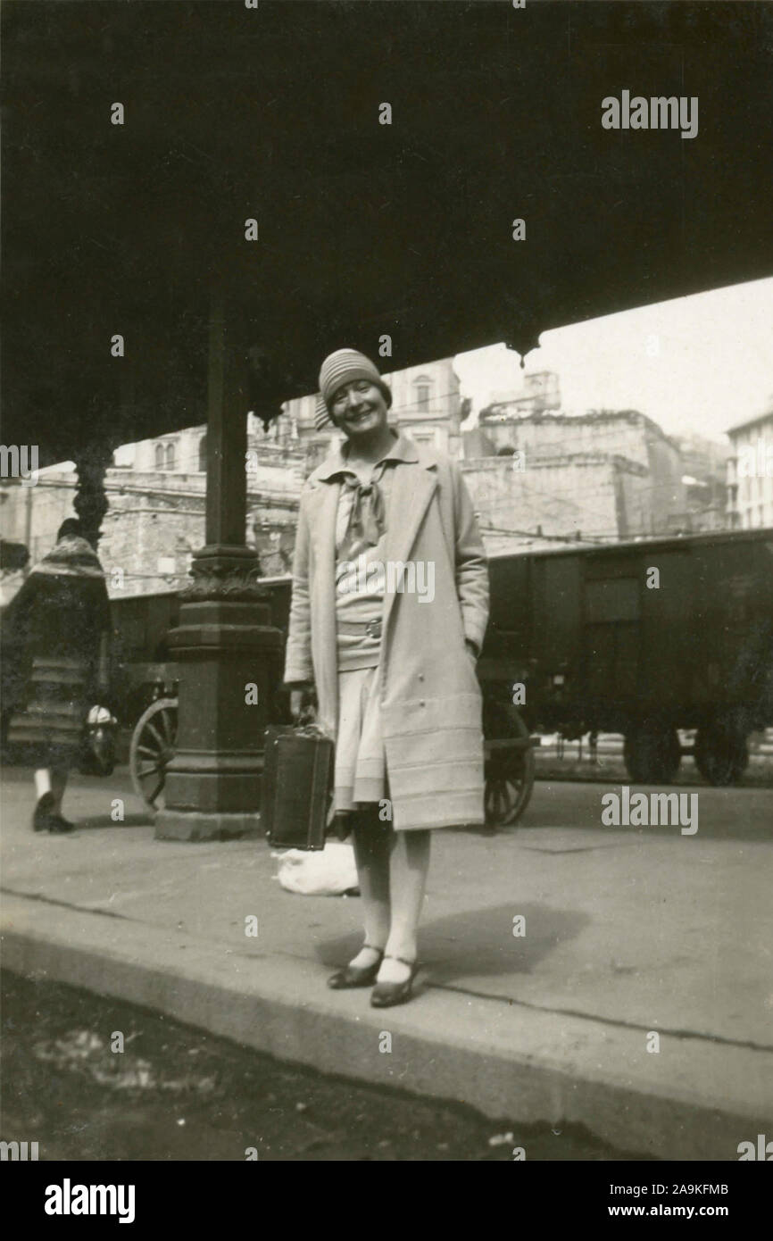An elegant woman with coat and hat at the station in Genoa, Italy Stock ...