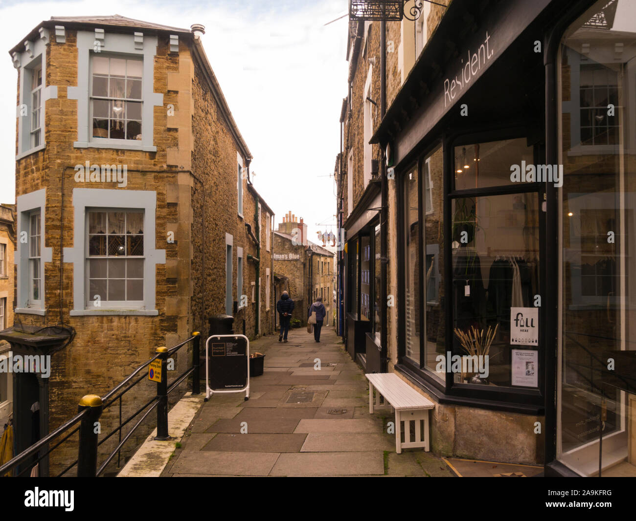 View along narrow Paul Street in Frome town centre with independent ...