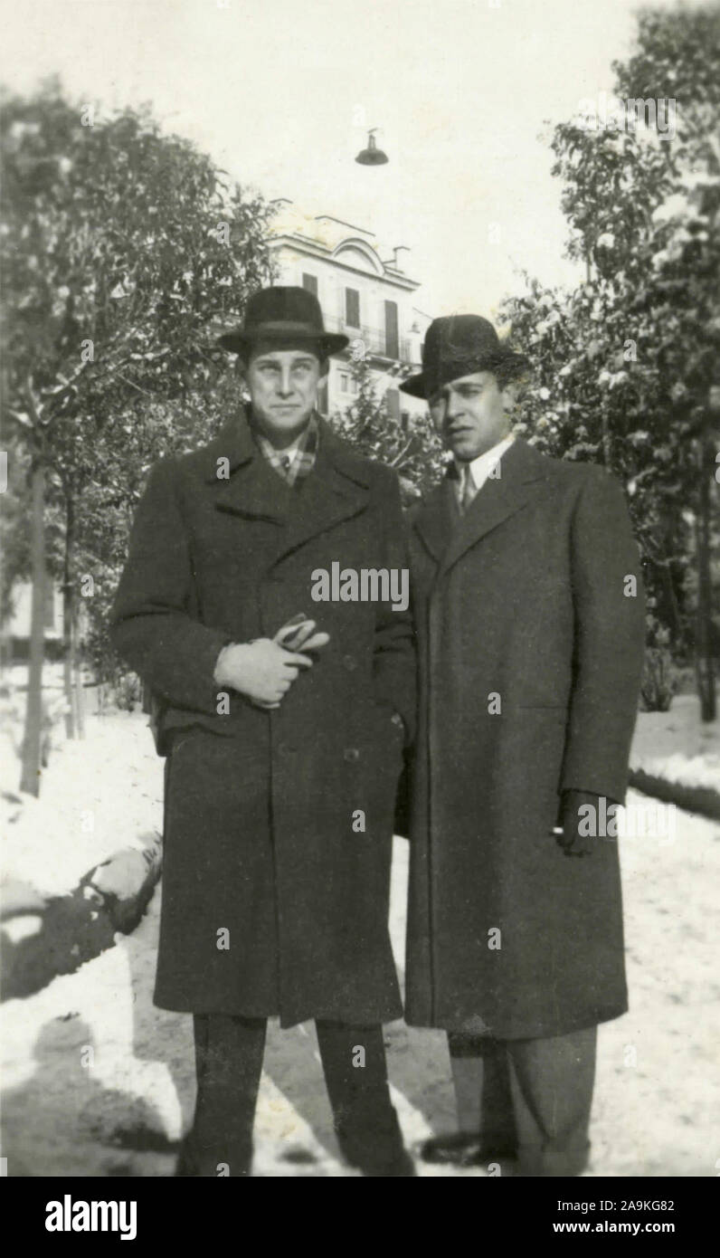 Father and son with hats and coats, Italy Stock Photo - Alamy