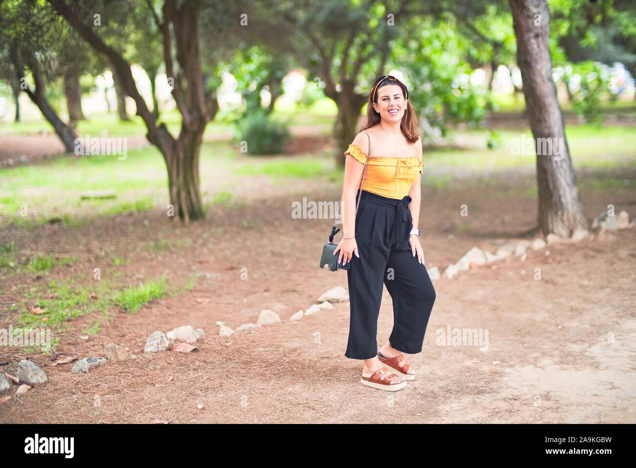 Young beautiful girl smiling happy and confident walking at the town ...