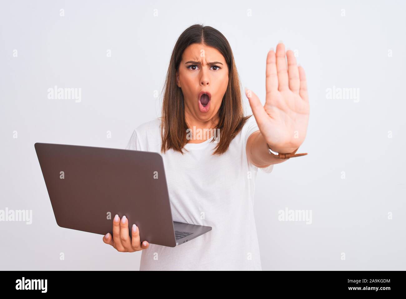 Beautiful young woman working using computer laptop over white ...