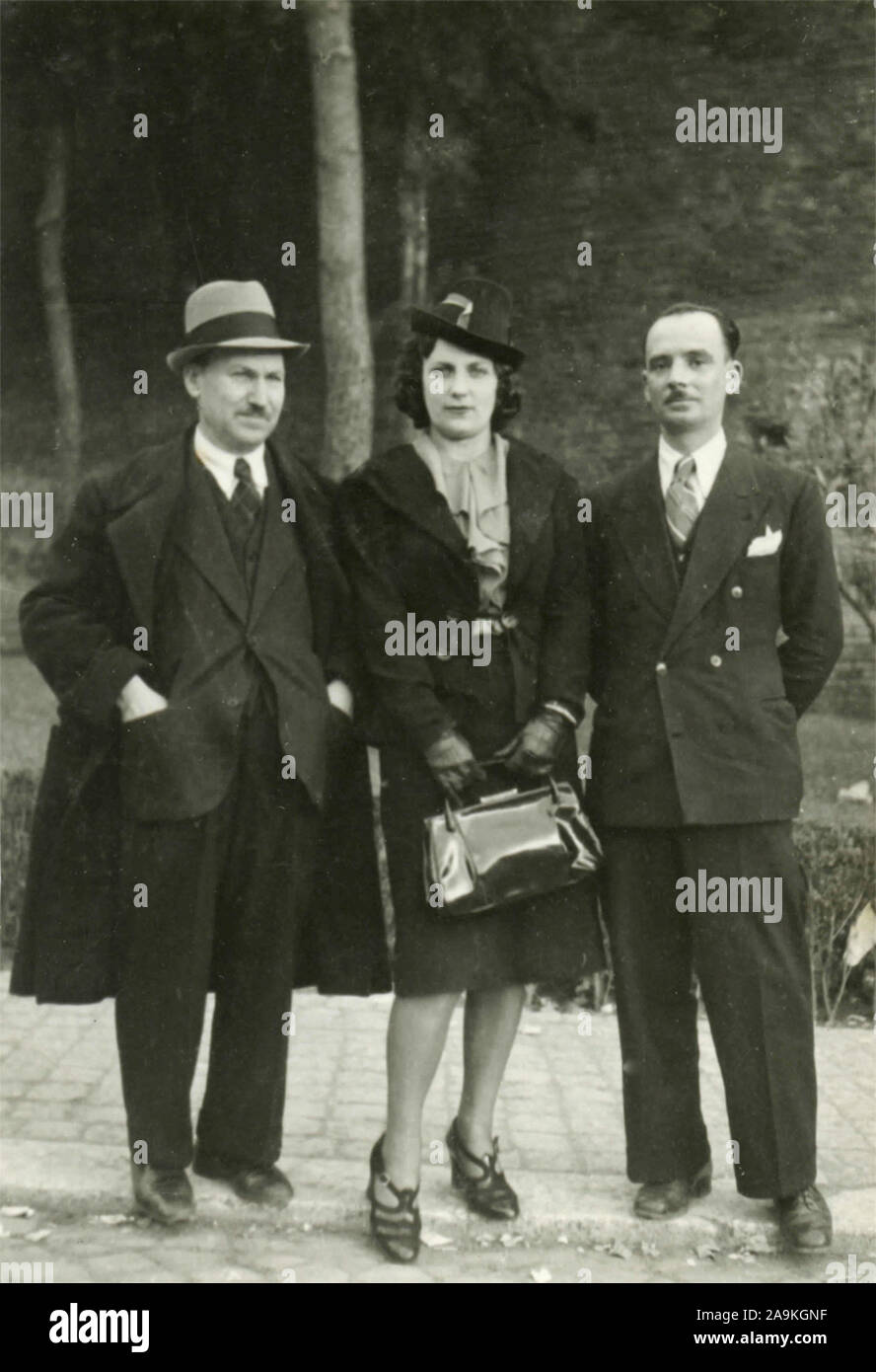 A woman with two men on the side, Italy Stock Photo - Alamy