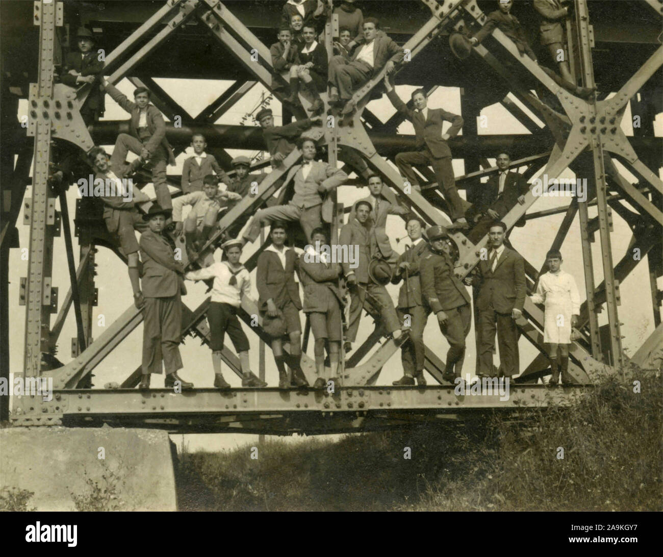 Group of children perched on an iron bridge Montesacro, Rome, Italy ...