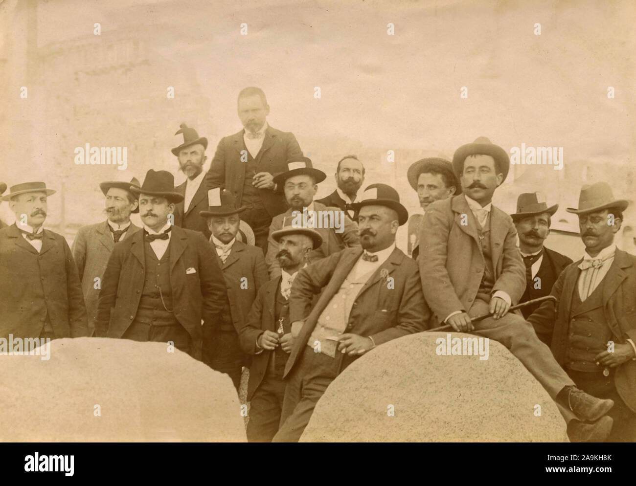 A group of men with the Coliseum in the background, Italy Stock Photo ...