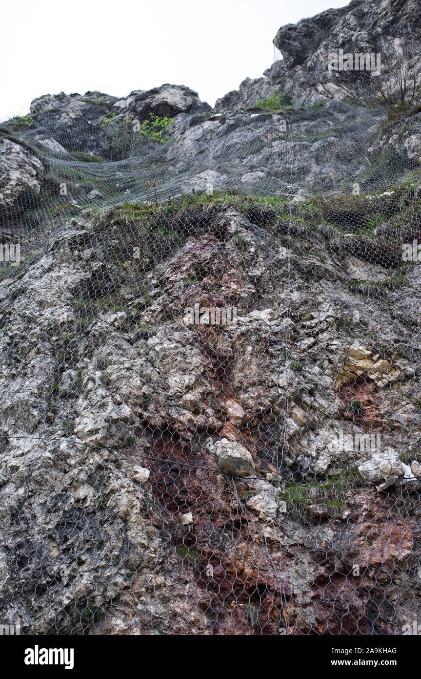 rockfall protection nets, installed to protect an rock wall Stock Photo ...