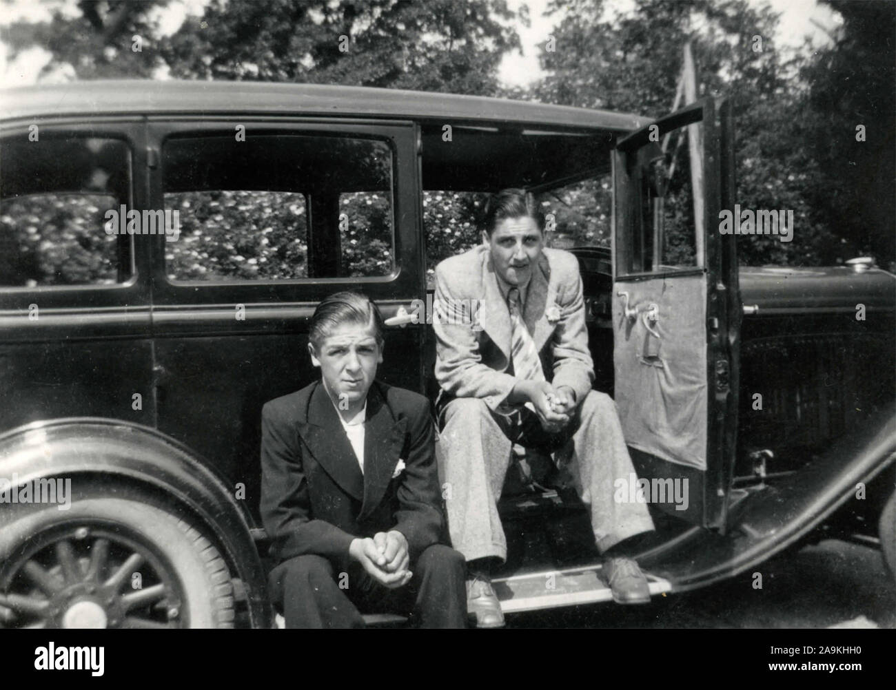 Two guys leaning on a car, Danmark Stock Photo - Alamy