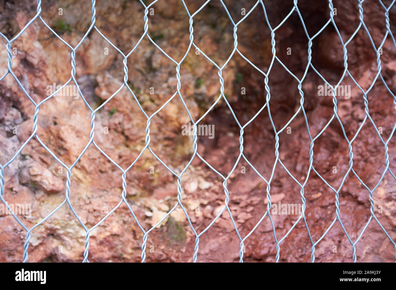 rockfall protection nets, installed to protect an rock wall Stock Photo ...