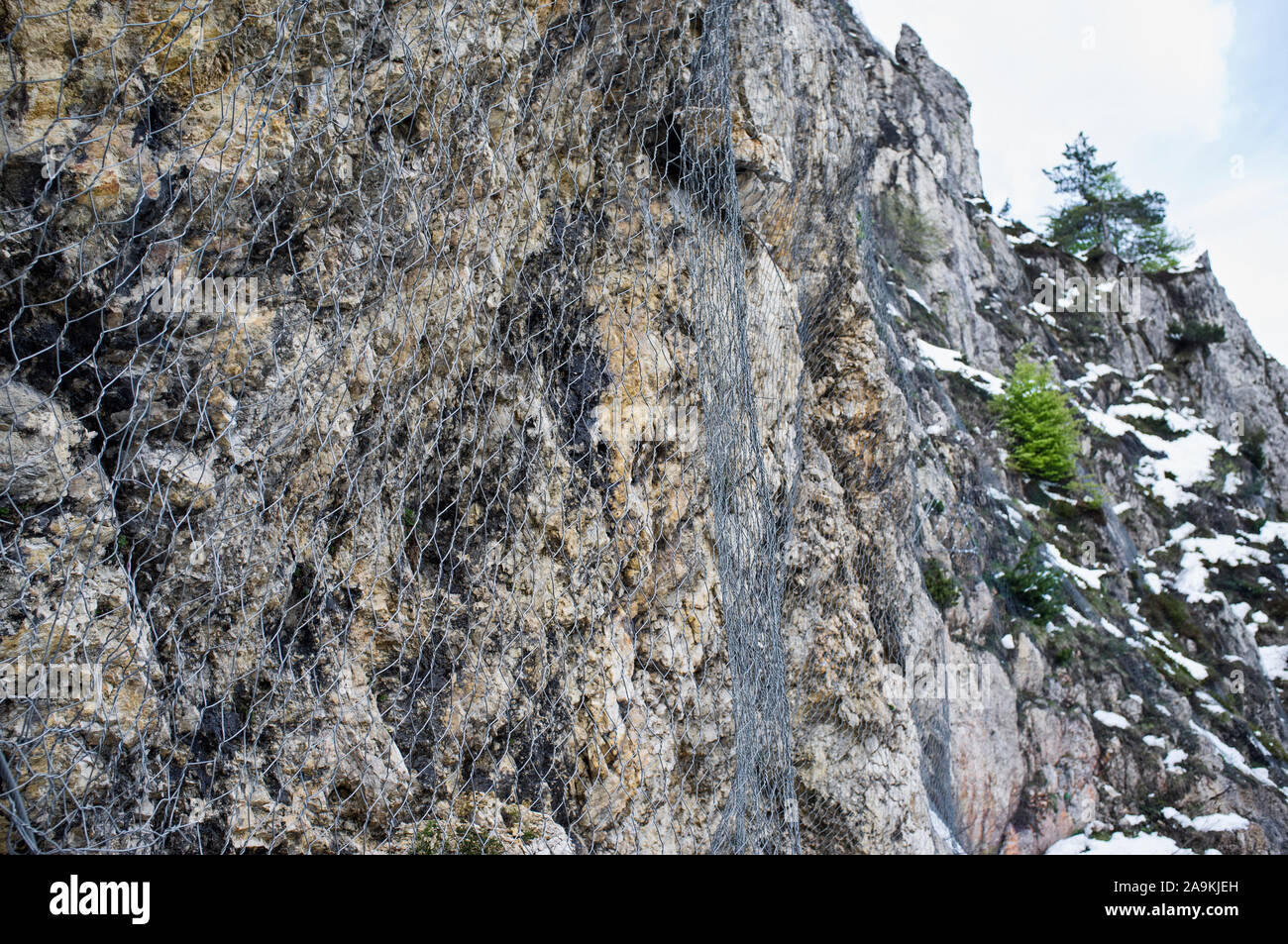 rockfall protection nets, installed to protect an rock wall Stock Photo ...