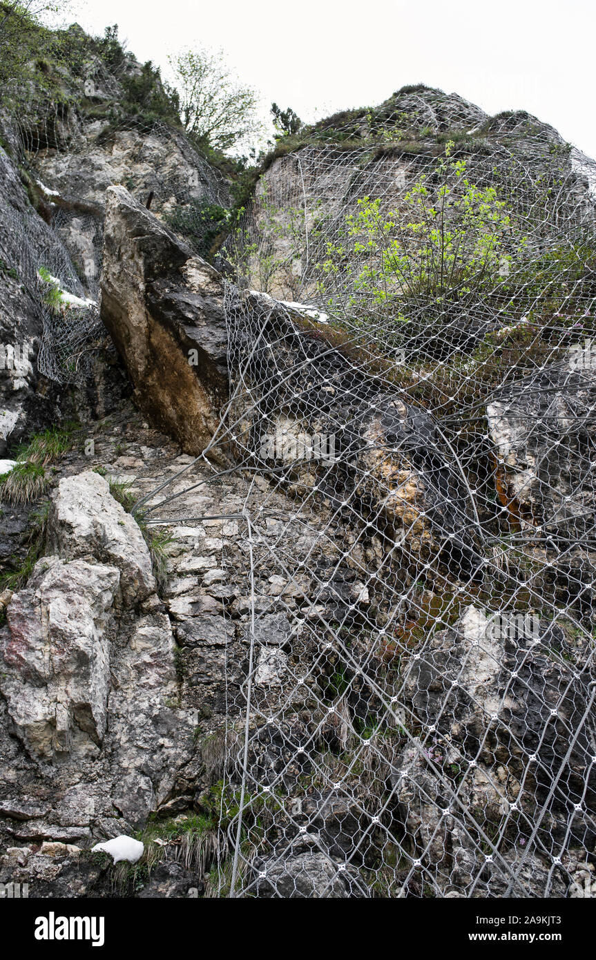 rockfall protection nets, installed to protect an rock wall Stock Photo ...