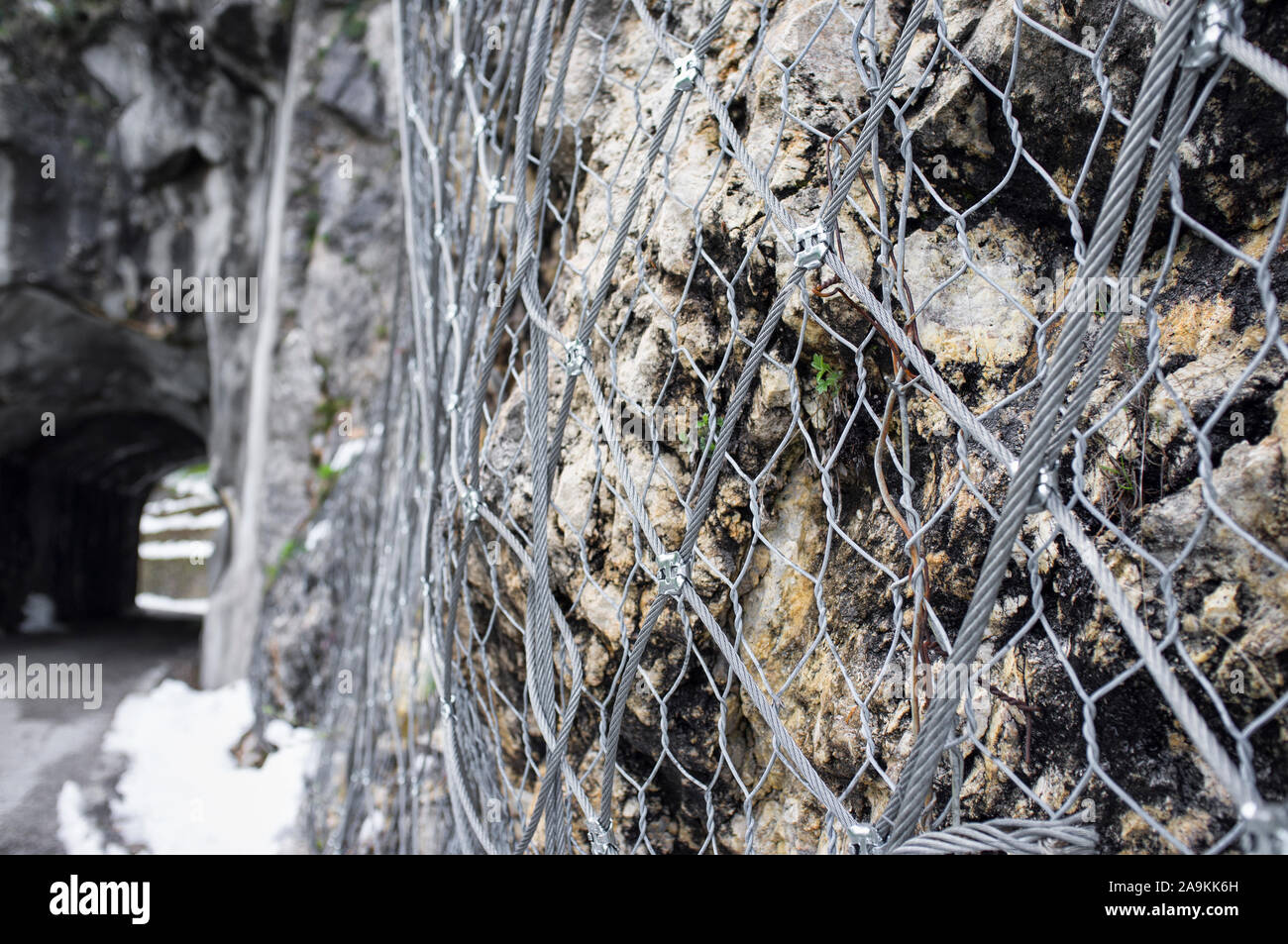 rockfall protection nets, installed to protect an rock wall Stock Photo ...