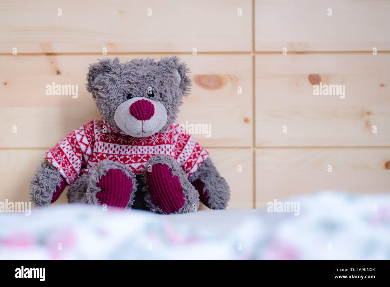 Cute teddy bear toy is sitting in the bed, wakeup at morning Stock ...