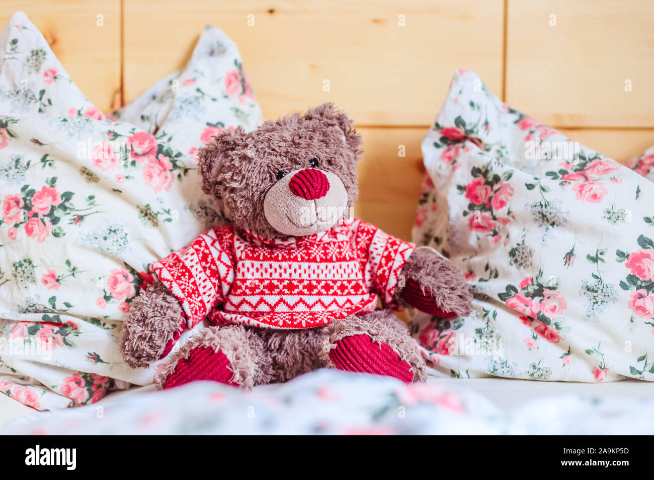 Cute teddy bear toy is sitting in the bed, wakeup at morning Stock ...
