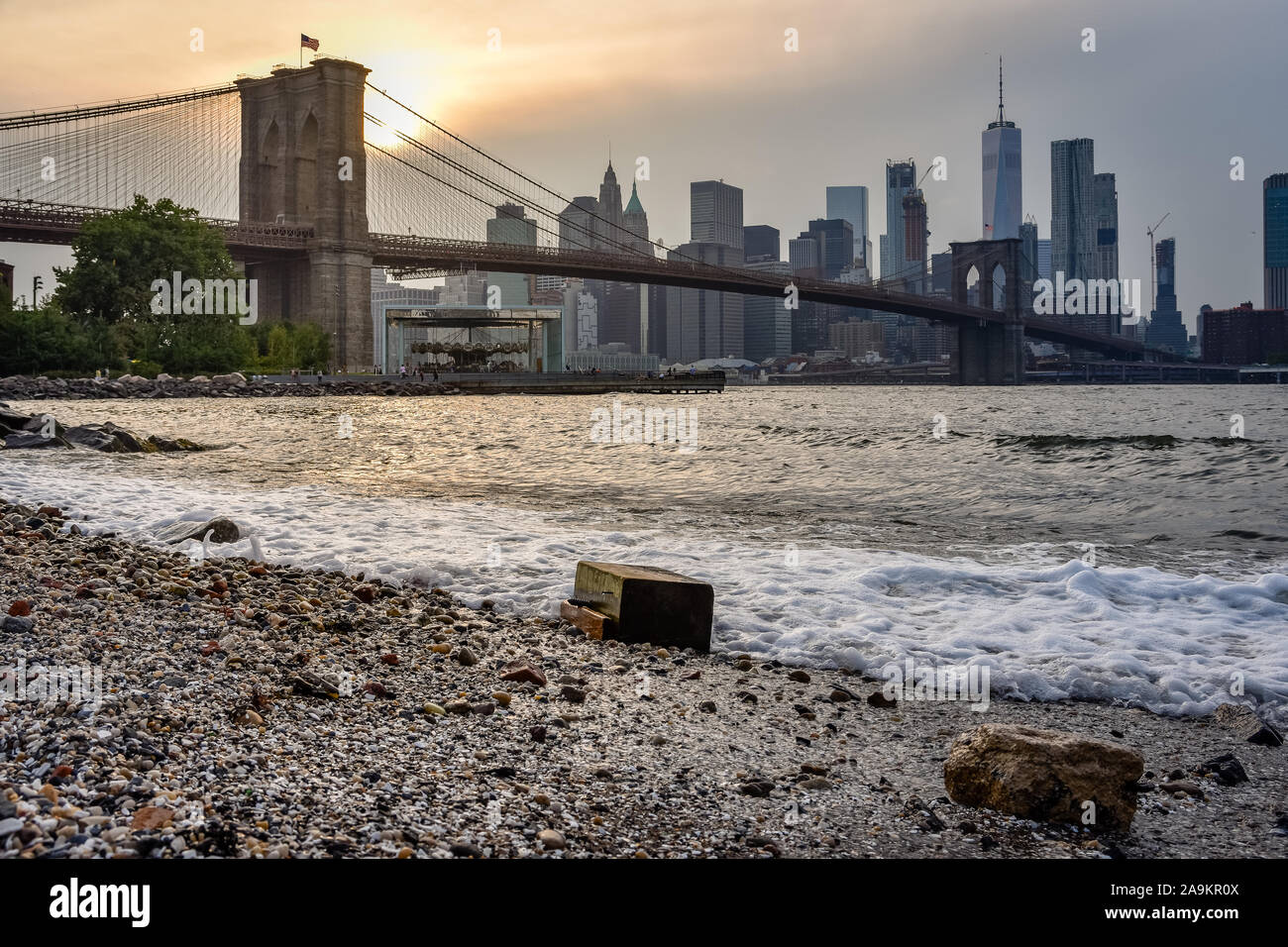 Brooklyn bridge and Manhattan skyline at dusk form Pebble Beach. NYC ...