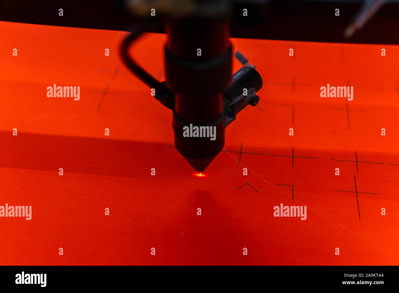 close-up of a flying head of a laser cutting machine, beam burning out ...