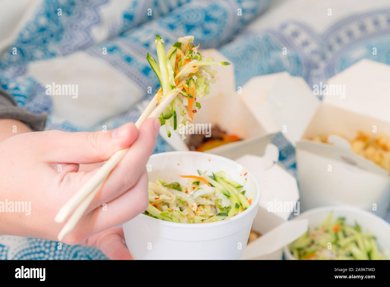 Eating Chinese Take Away Food With Chop Sticks At Home With Bed Sheets ...