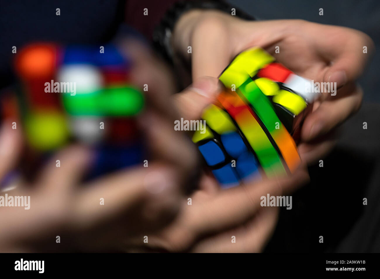 A young man solving Rubik's cube puzzle at the shortest time Stock ...