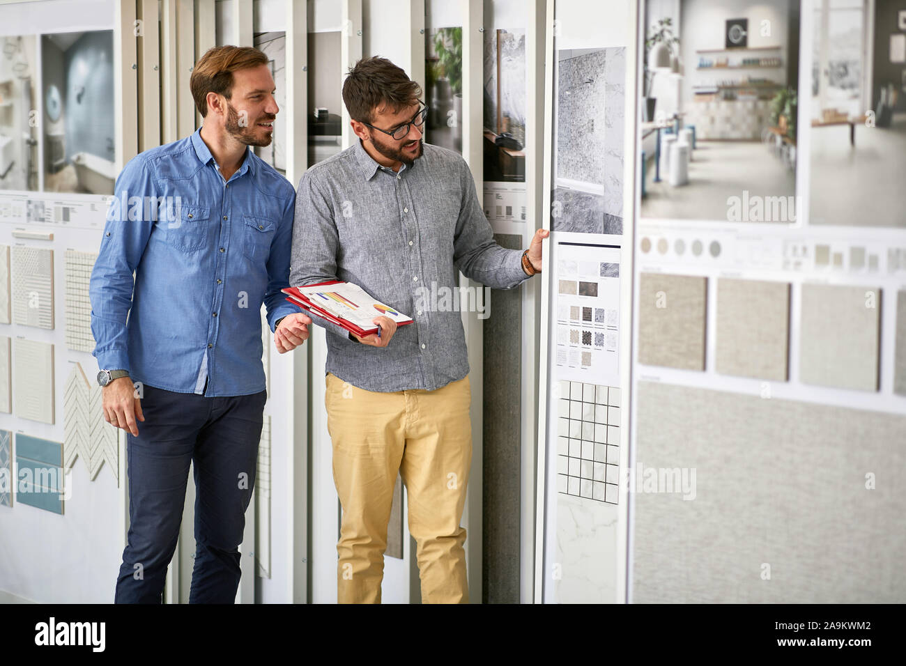 Young man with salesman in store for the house Stock Photo - Alamy