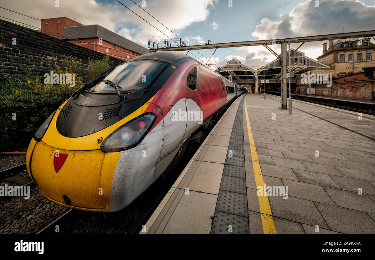 A modern high-speed train at the station on a cloudy day, showcasing ...