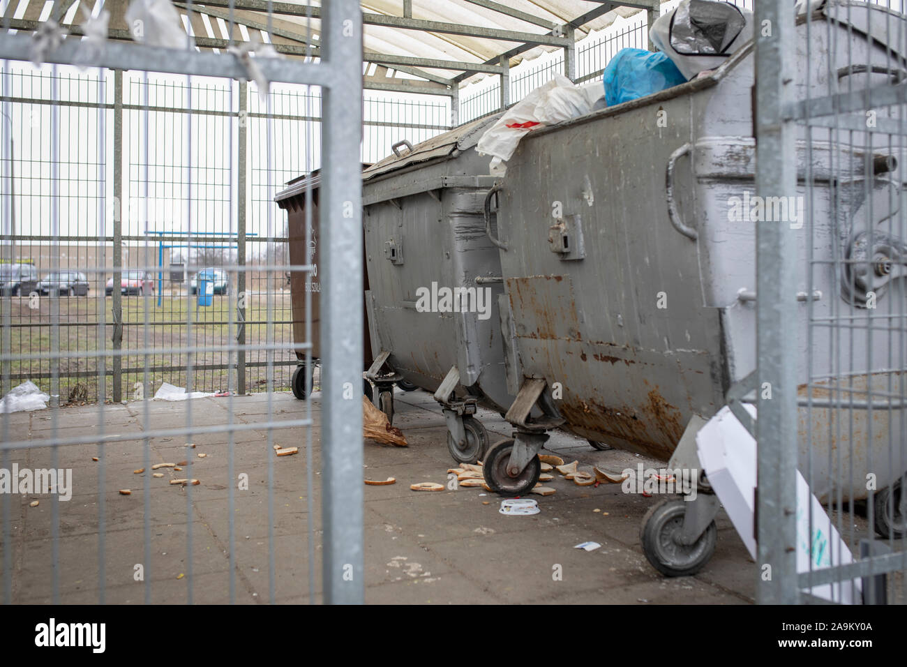 Garbage container, mess, rubbish, bottles on the ground Stock Photo - Alamy