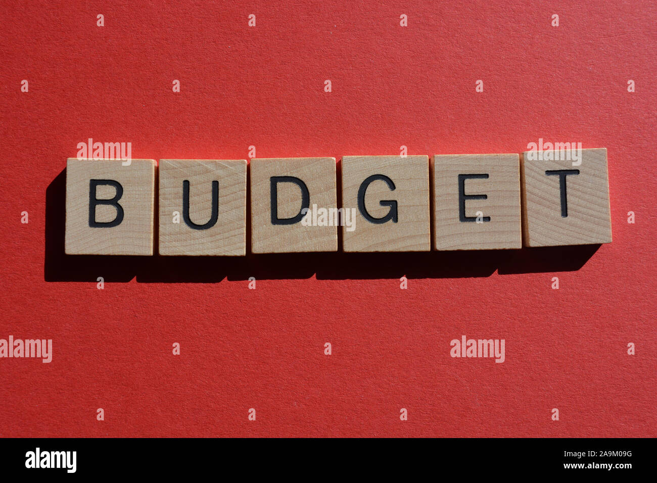 Budget, word in 3d wooden alphabet letters on a red background Stock ...