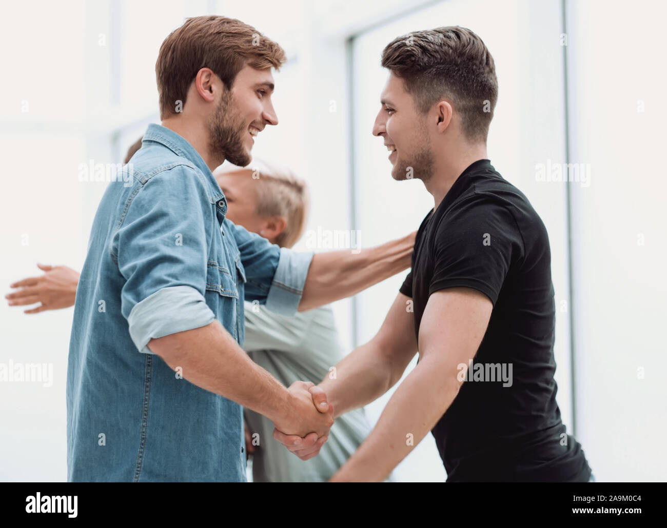 happy coworkers hugging each other when meeting Stock Photo - Alamy