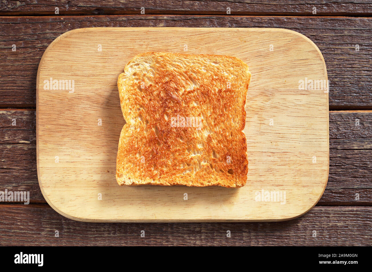 Slice of toasted bread on kitchen board, top view Stock Photo - Alamy
