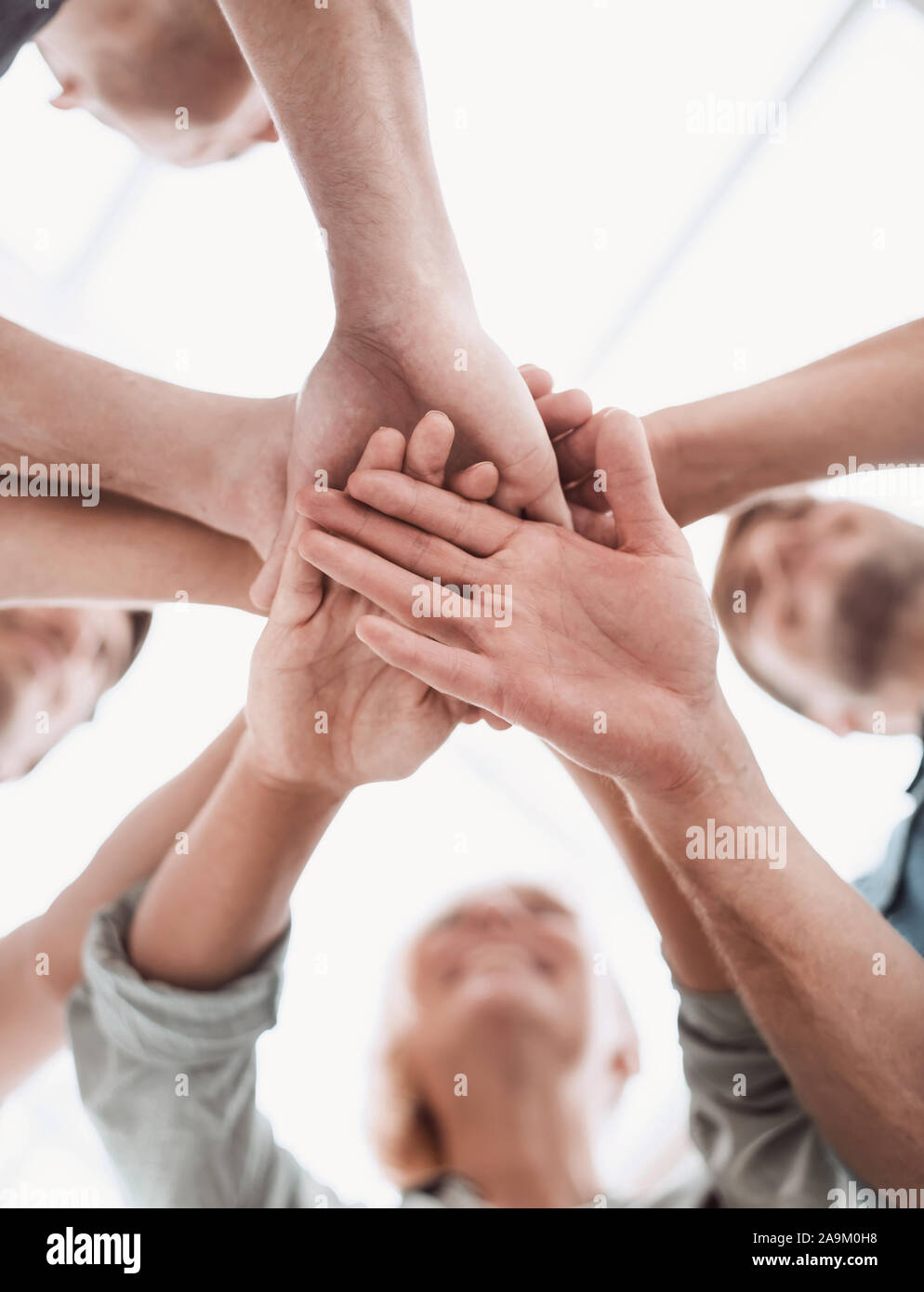 close up. business team putting their hands together Stock Photo - Alamy