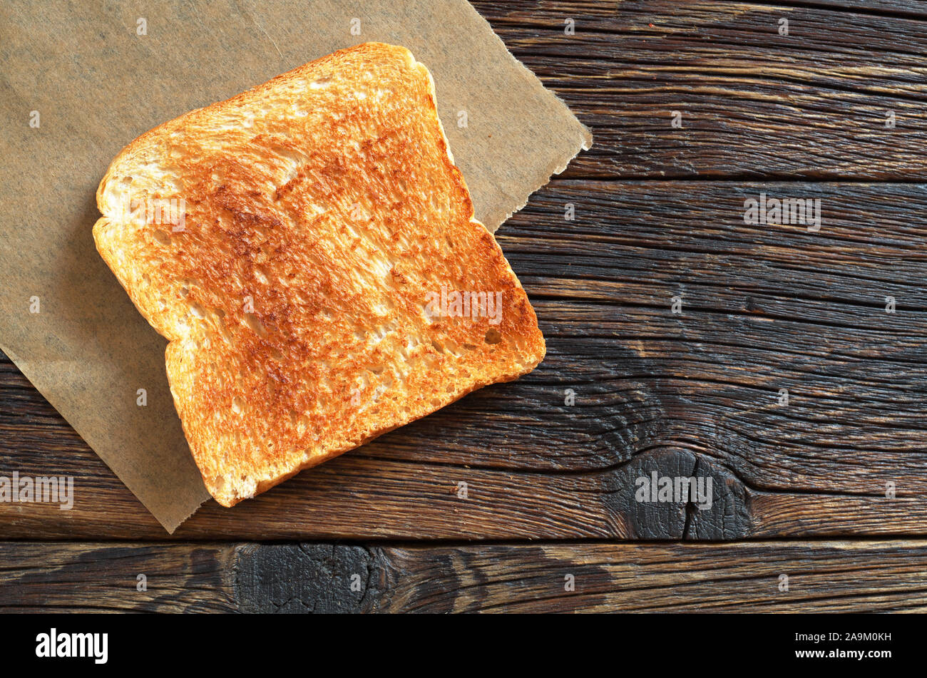 Slice of toasted bread on wooden table, top view. Space for text Stock ...
