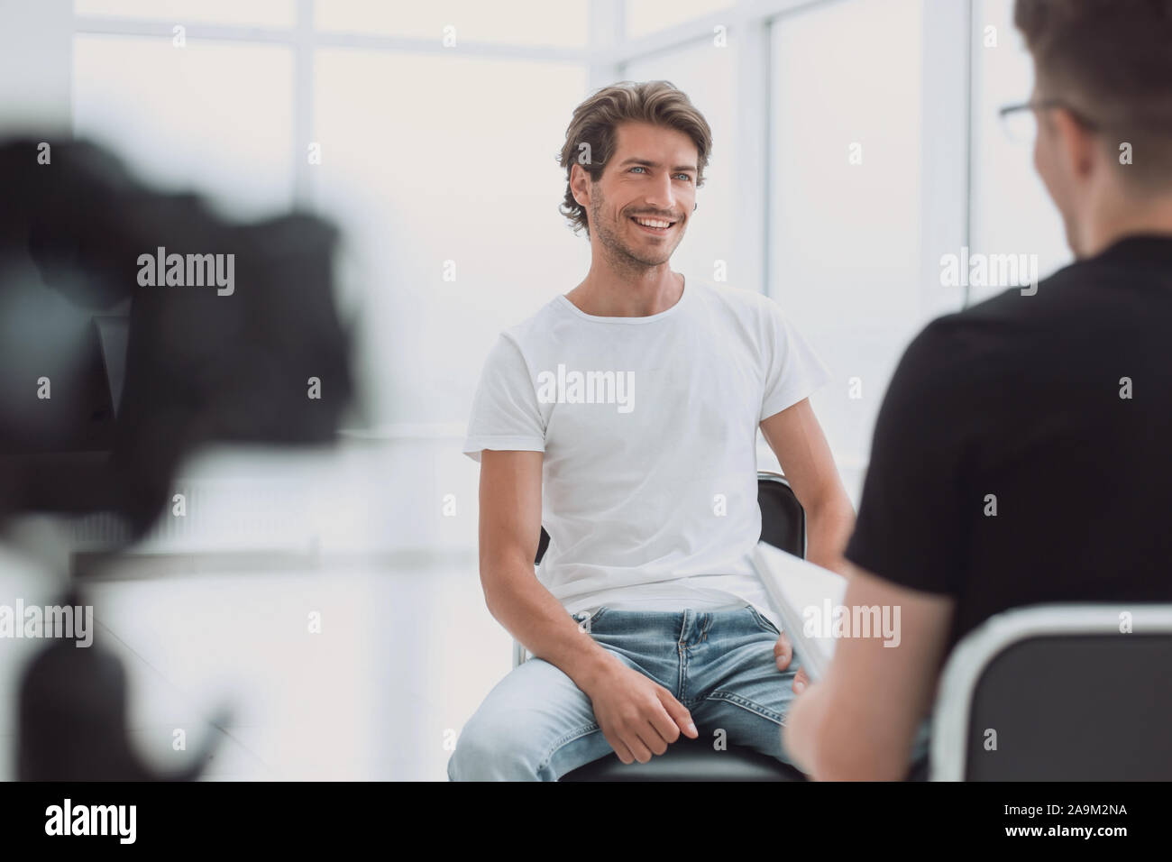 close up. a young businessman gives an interview in the office Stock ...