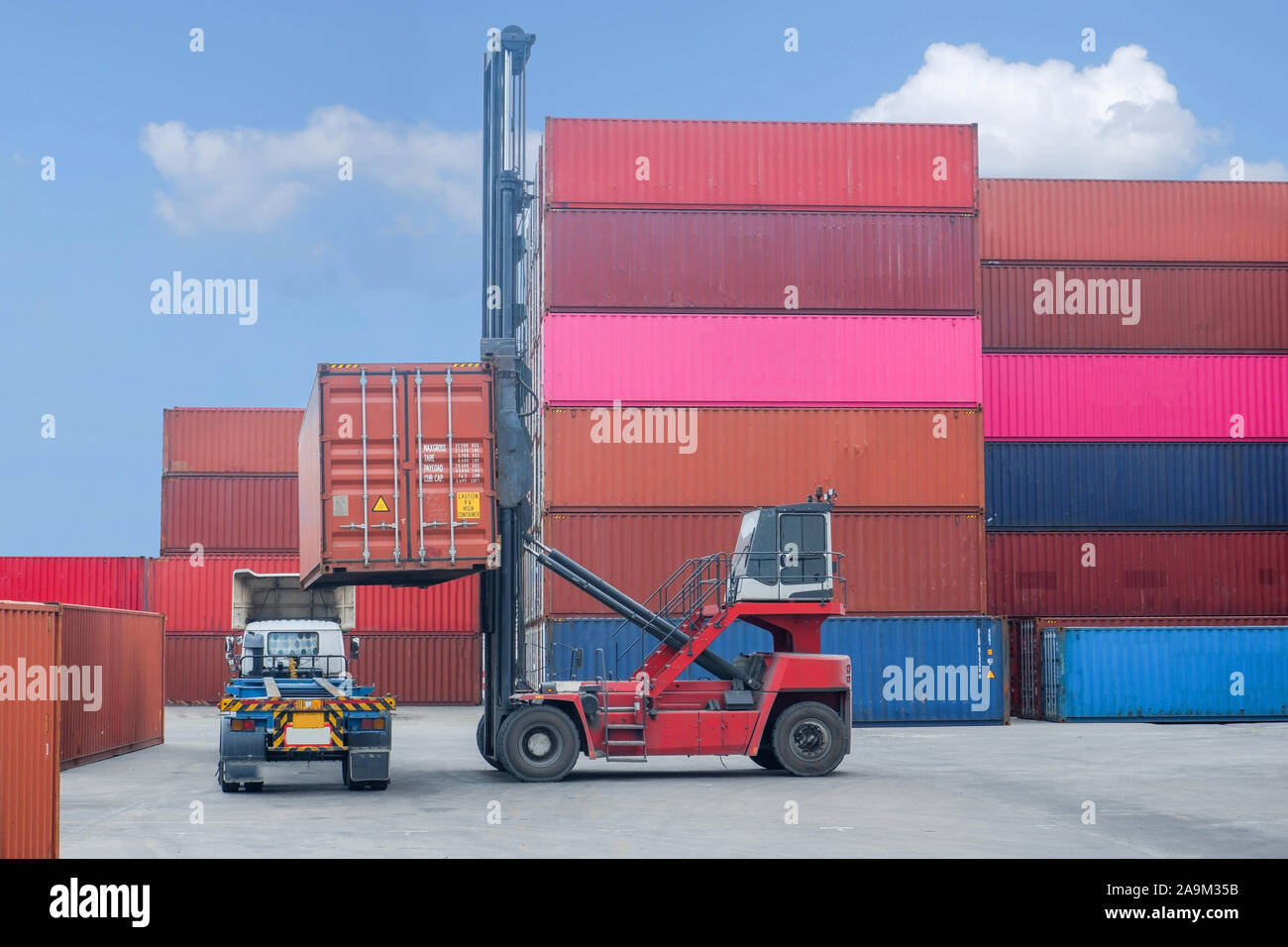 Container handlers In the shipping dock with storage cabinet background ...