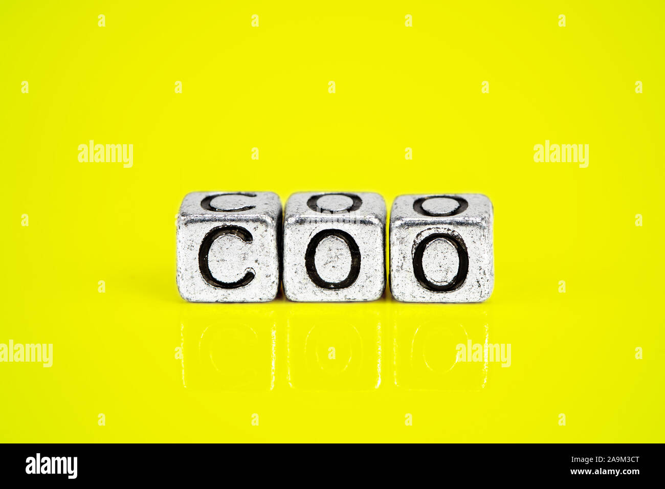 Chief Operating Officer COO concept with cubic metal letters on yellow ...