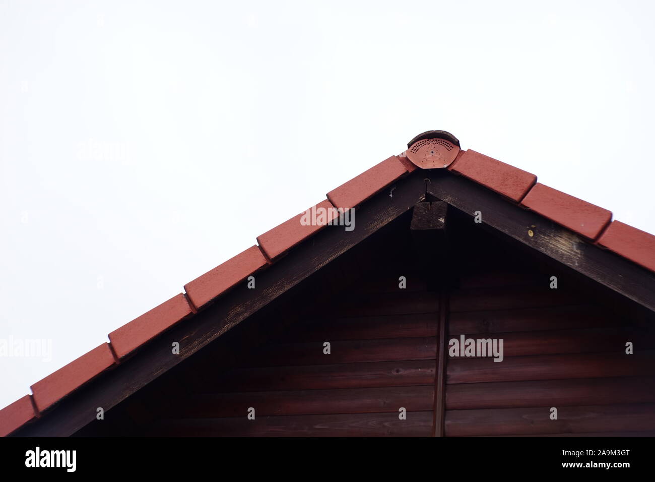 Part of the pediment of a wooden house with a red roof metal tile Stock ...