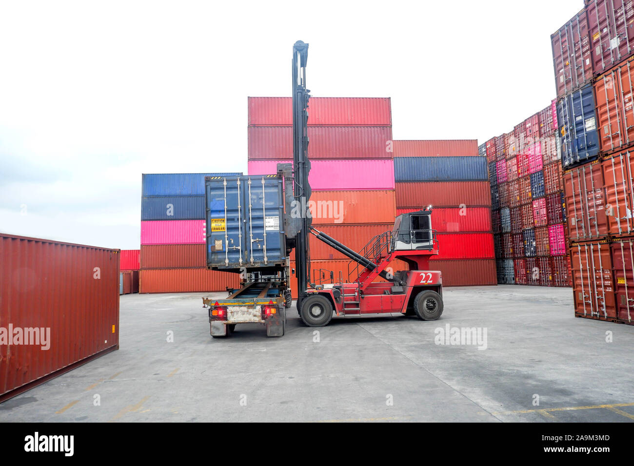 Container stacker, load the container into the truck. Work in the cargo ...