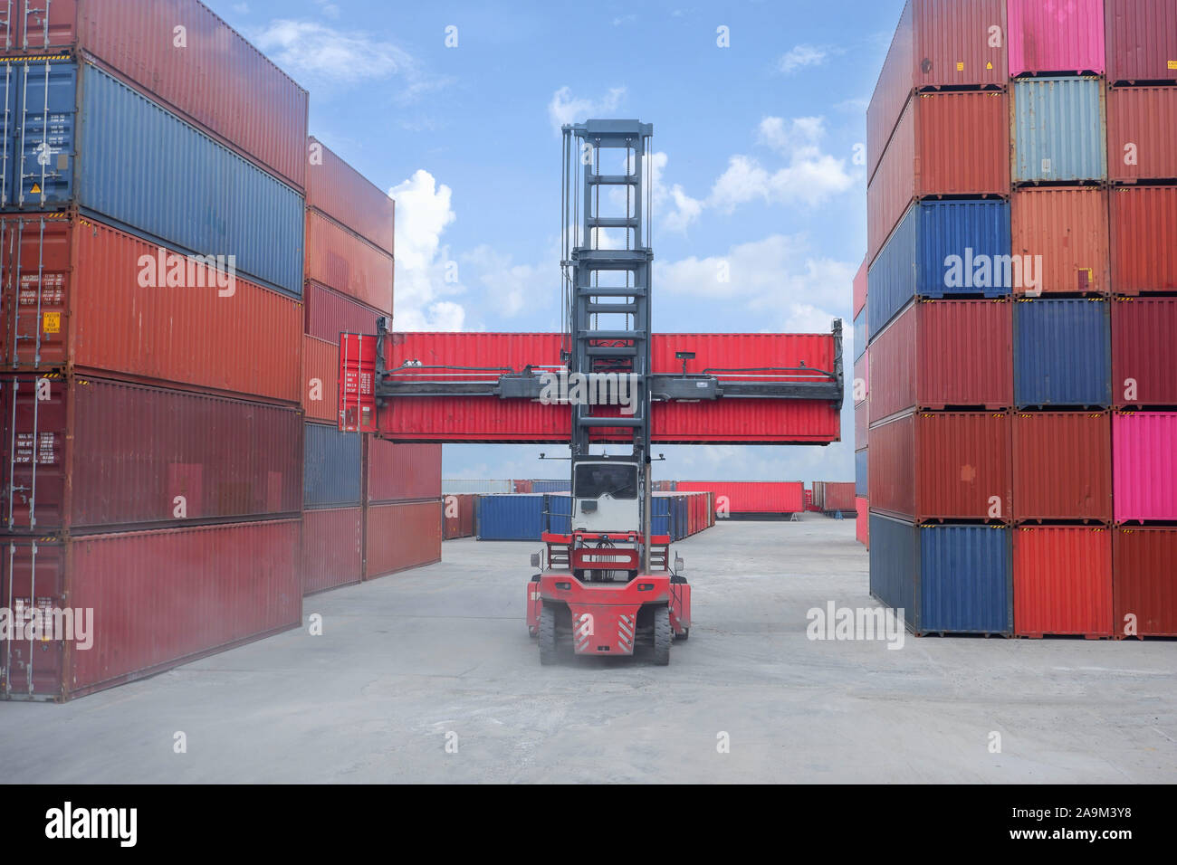 Container handlers work in cargo ports, cargo stations Stock Photo - Alamy