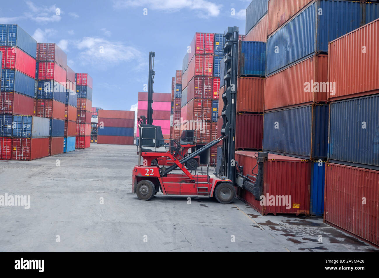 Container handlers work in cargo ports, cargo stations Stock Photo - Alamy