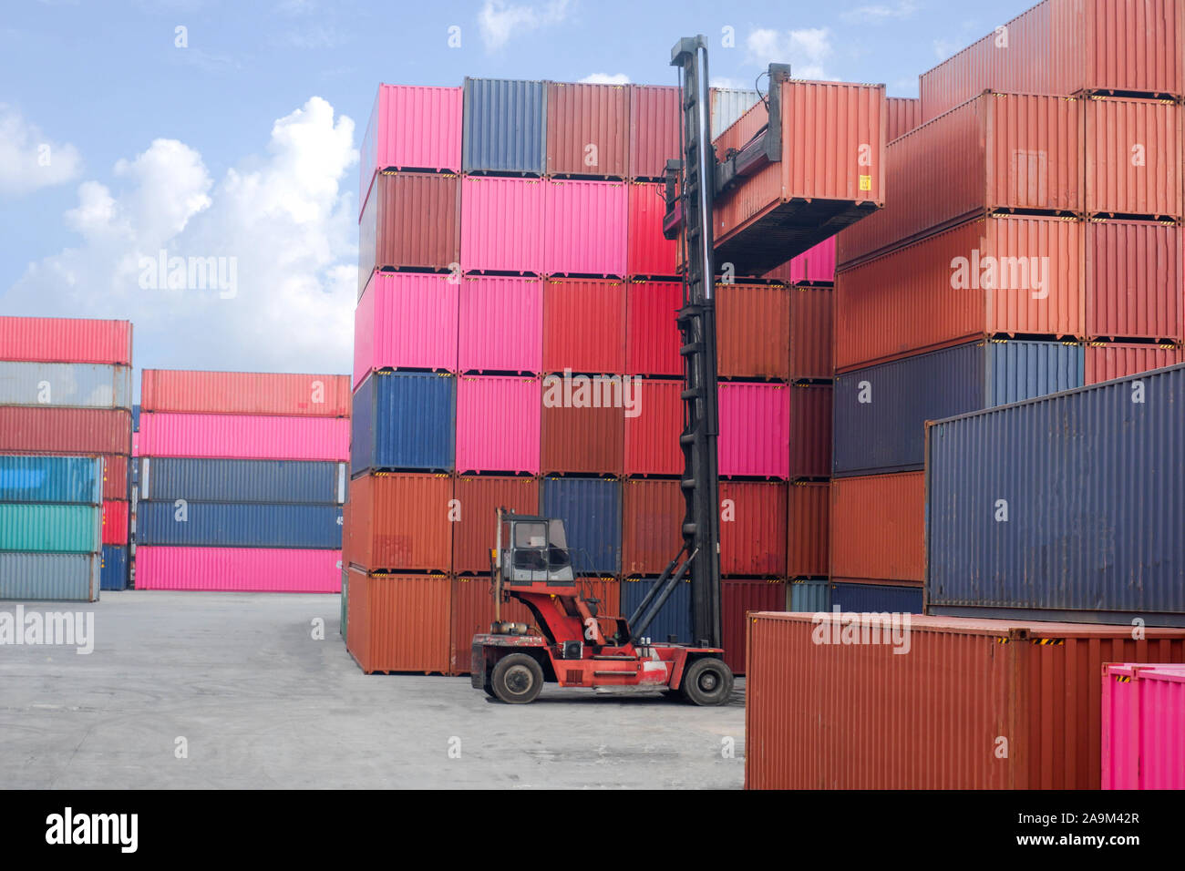 Container handlers work in cargo ports, cargo stations Stock Photo - Alamy